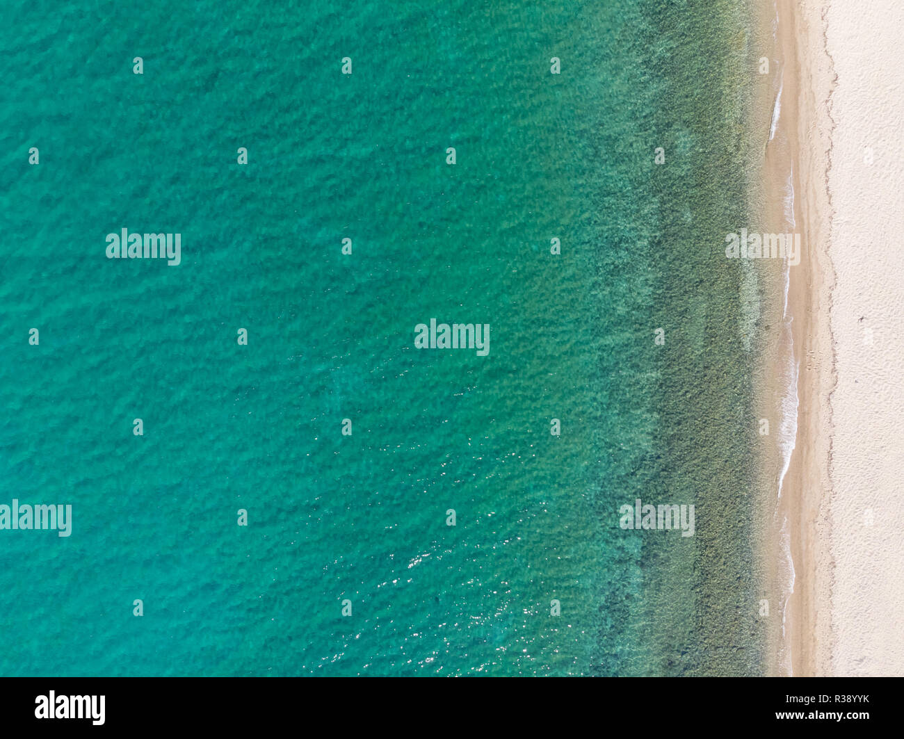 Drone aerial view from above of sandy beach, green and blue sea water ...
