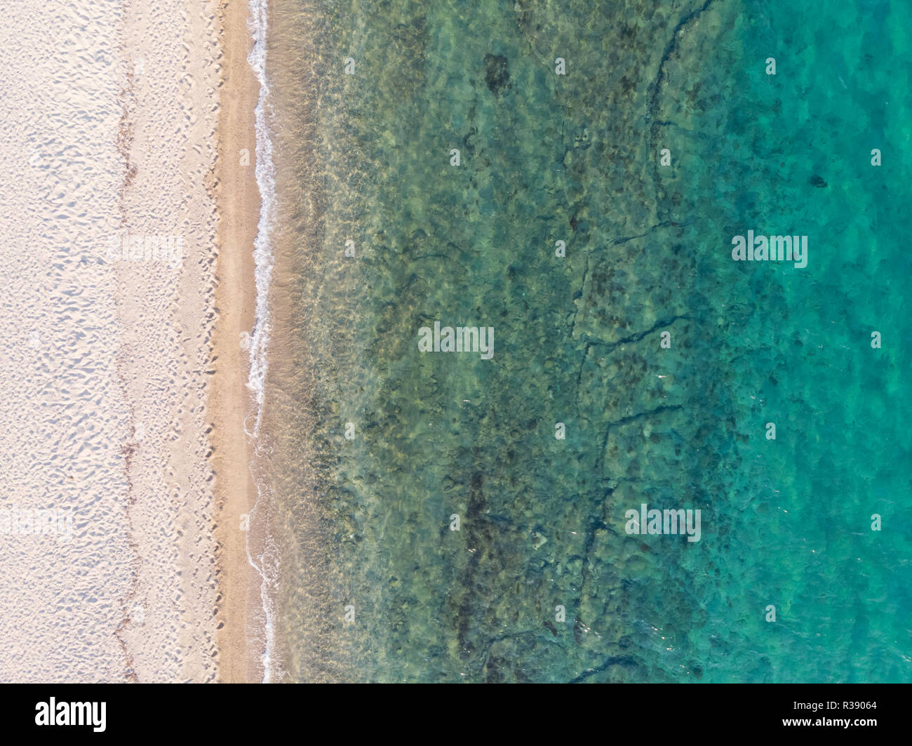 Drone aerial view from above of sandy beach, green and blue sea water ...