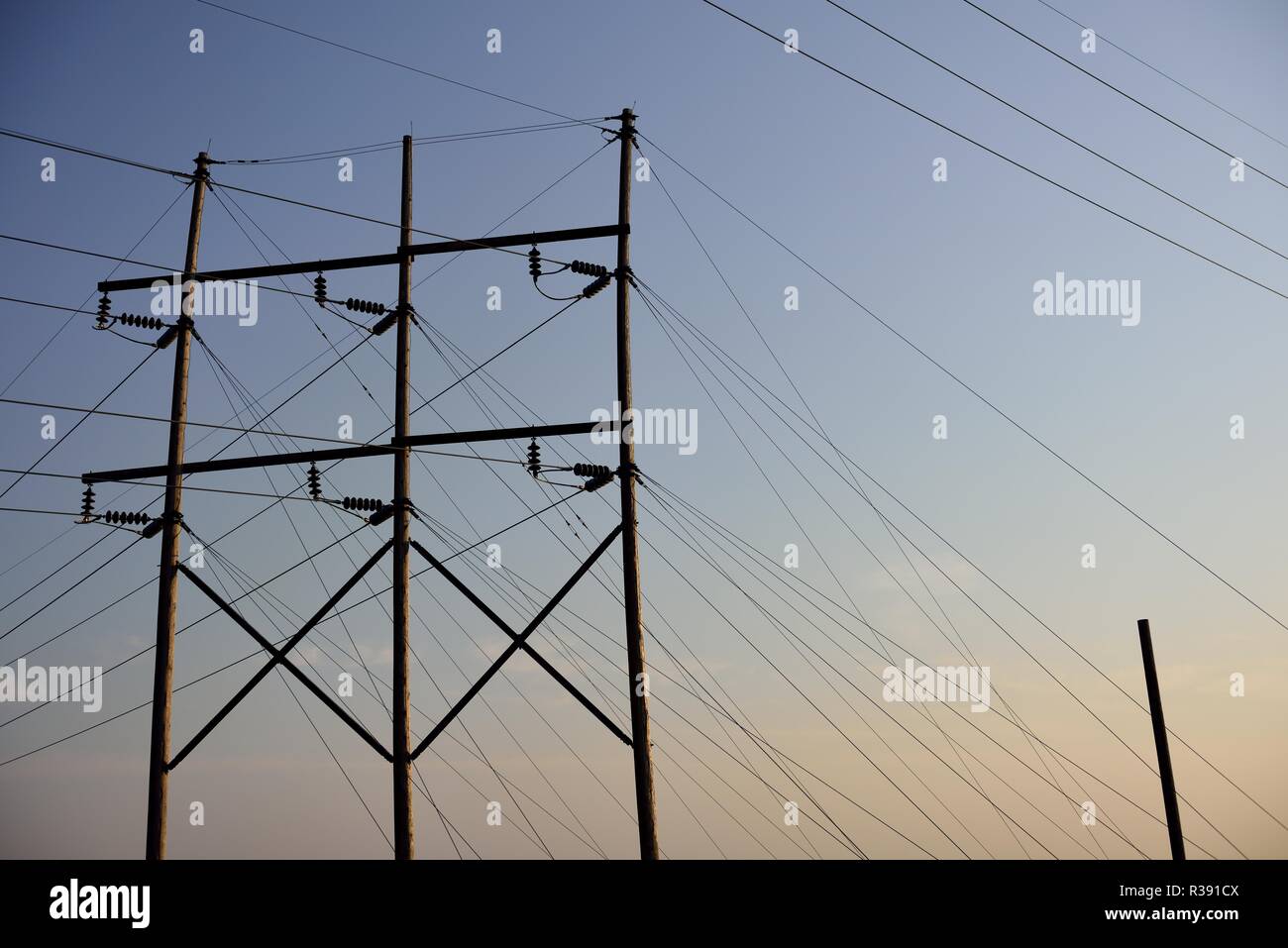 Electrical utility poles and overhead high voltage power lines at ...