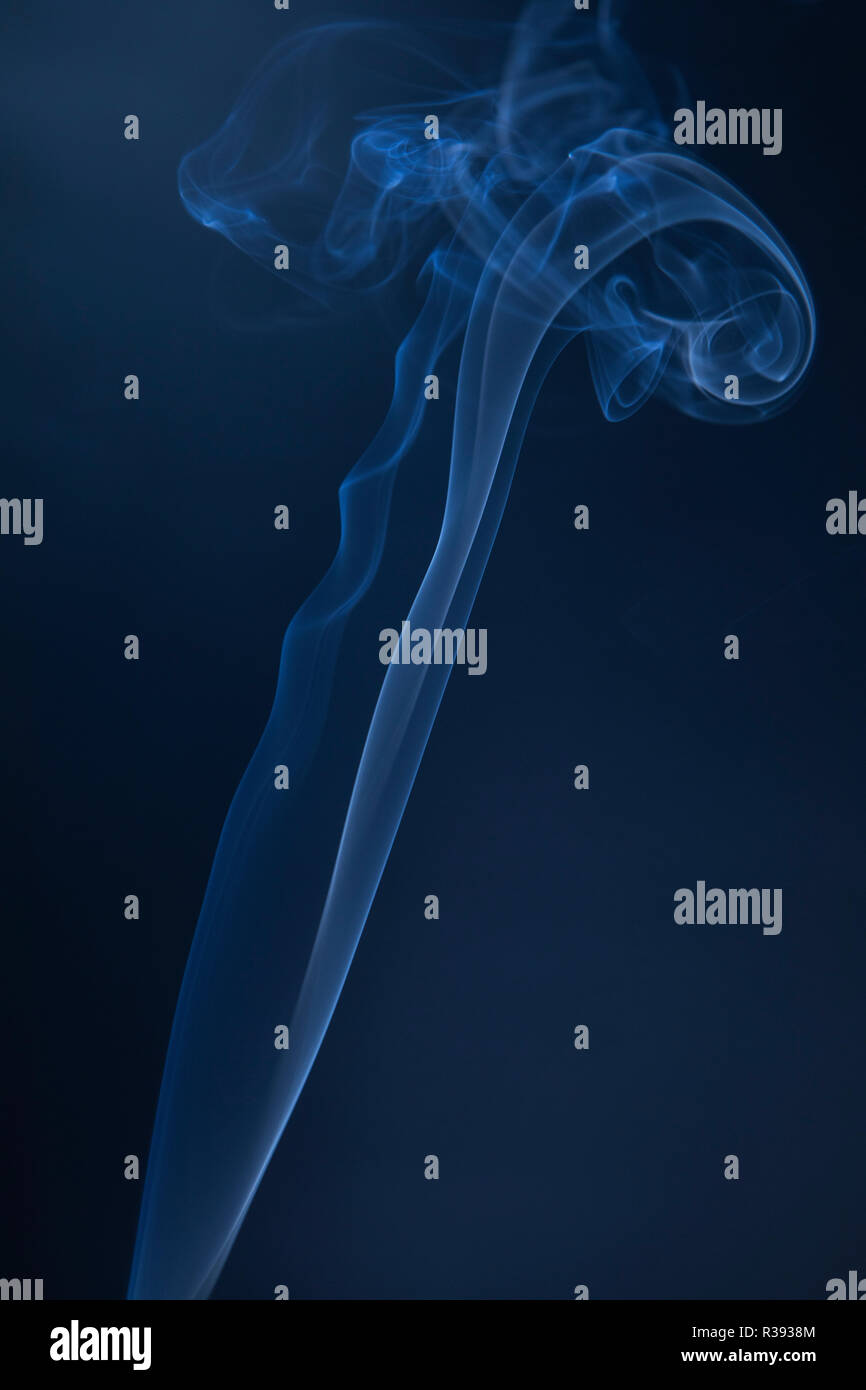 Abstract blue smoke swirls on dark background Stock Photo - Alamy