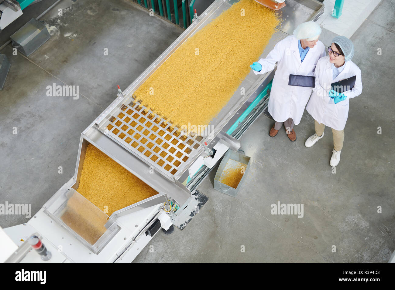 Workers Overseeing Production at Factory Stock Photo - Alamy