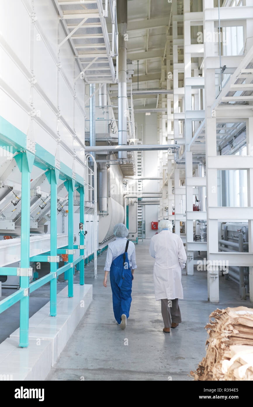 Workers Crossing Modern Workshop Stock Photo - Alamy