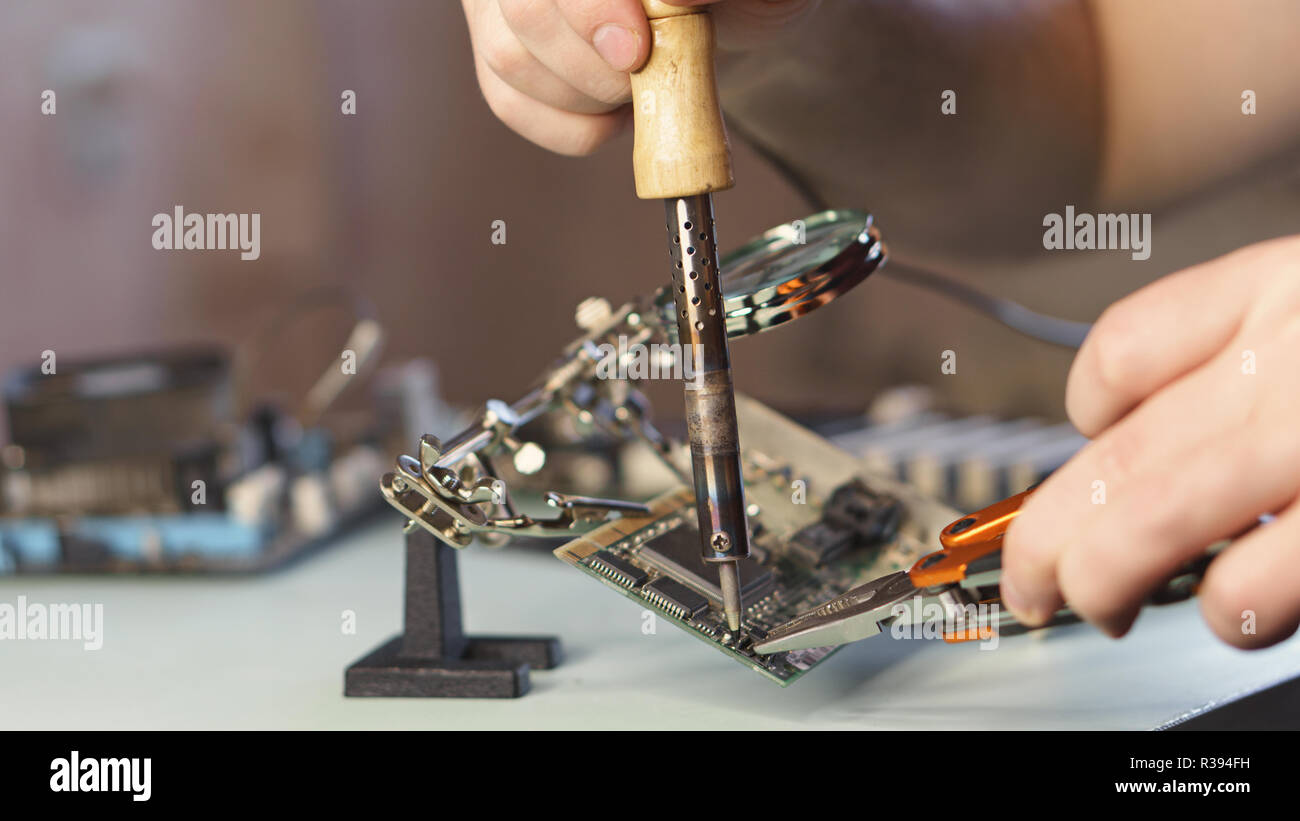 Repair motherboard. Service technician changes microcontroller on ...