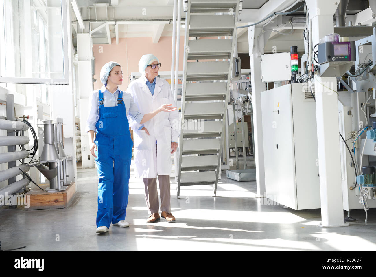 Worker Giving Tour of Factory Stock Photo - Alamy