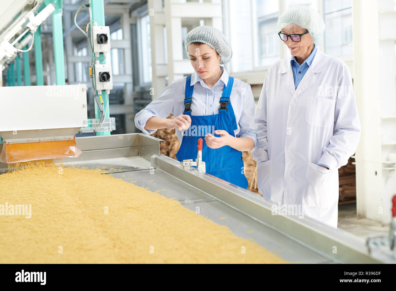 Senior Worker Helping Trainee Stock Photo - Alamy