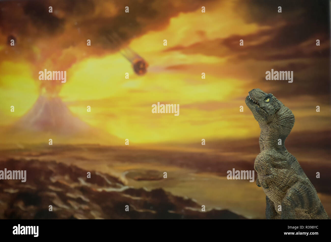 Baby tyrannosaurus rex with volcano in the background Stock Photo - Alamy