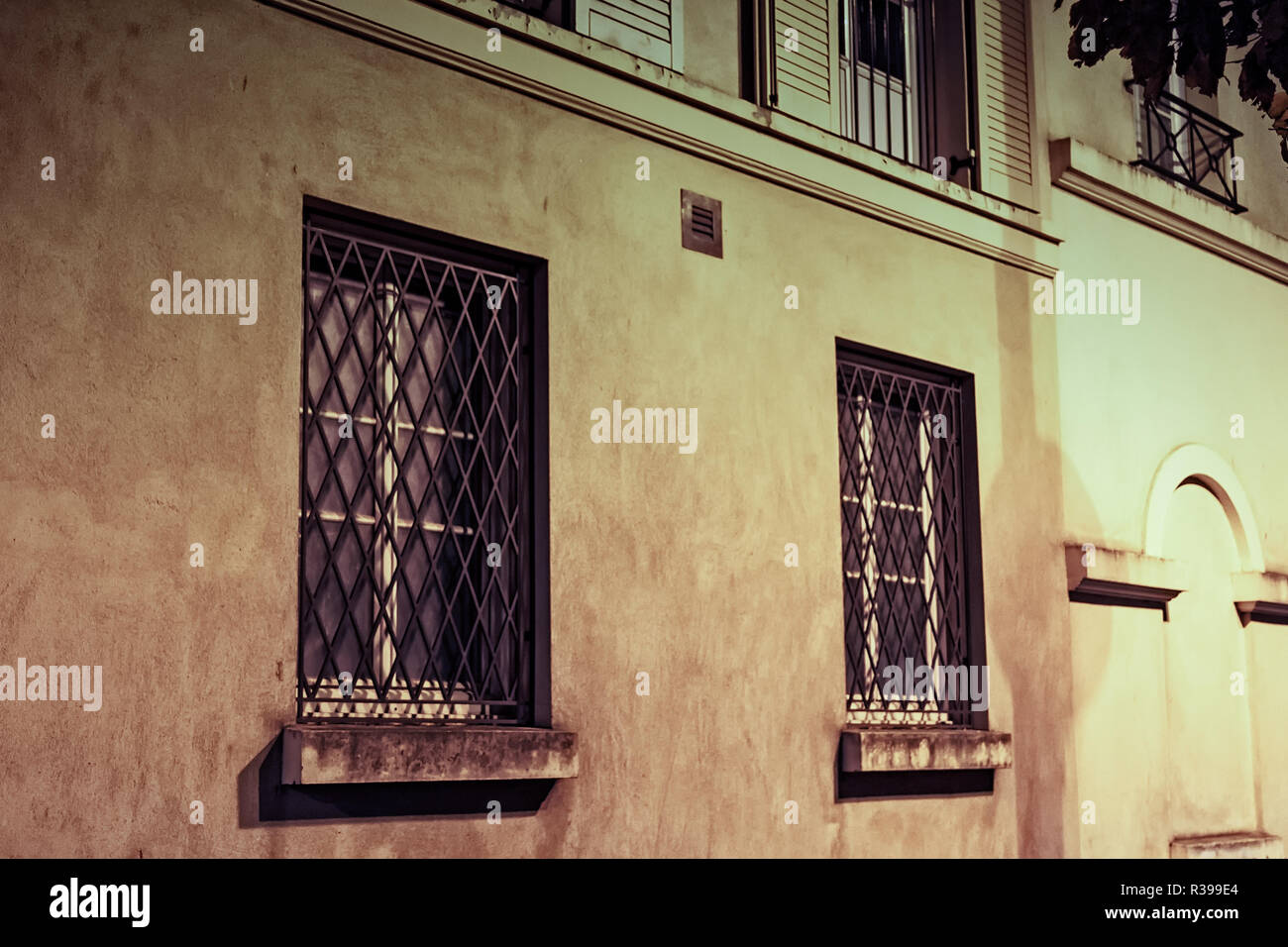 Two windows on a wall on an autumn night in Serris, France. The windows ...