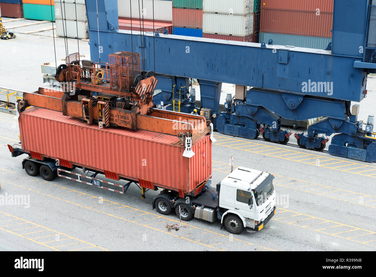 Industrial crane loading Containers in a Cargo freight ship. Container ...
