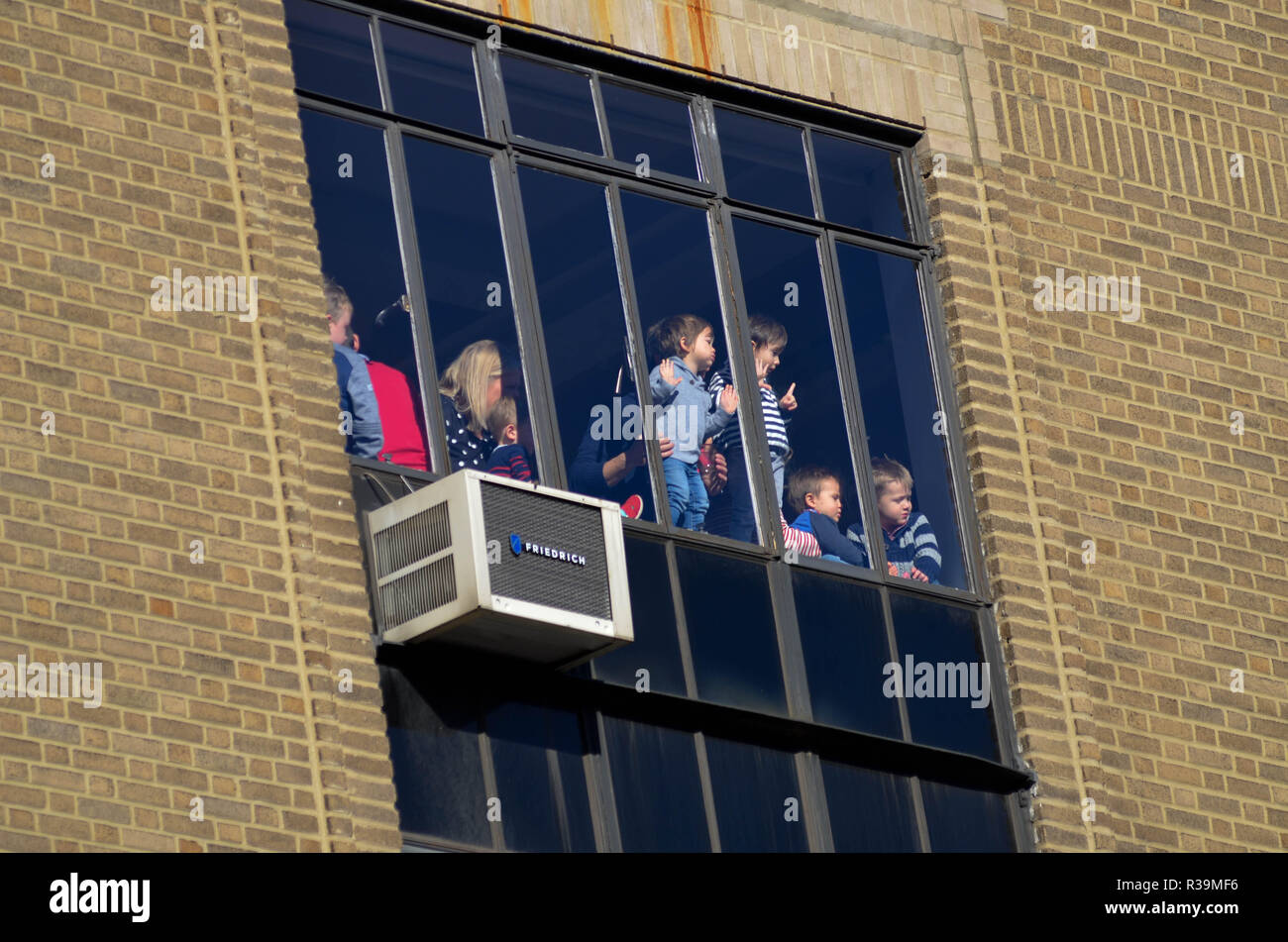 Kids seen in a building window trying to watch the 92nd annual Macy's ...