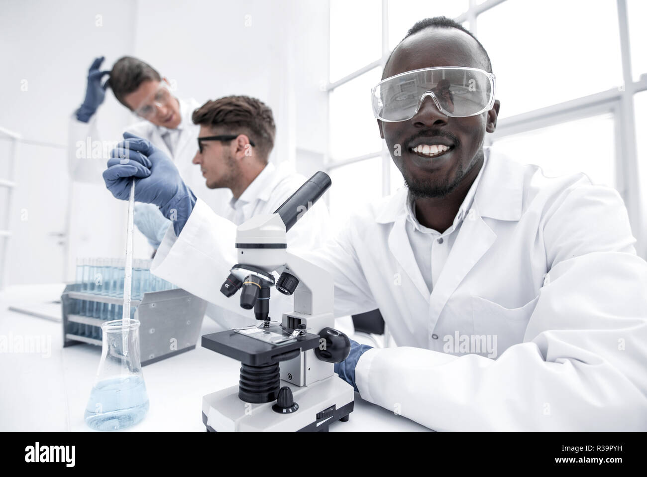 modern scientist uses a microscope in a laboratory Stock Photo - Alamy