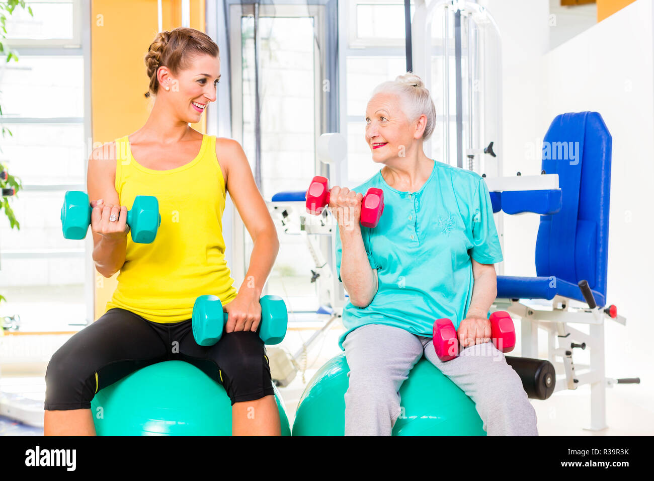 two women dumbbell workout at the gym Stock Photo - Alamy