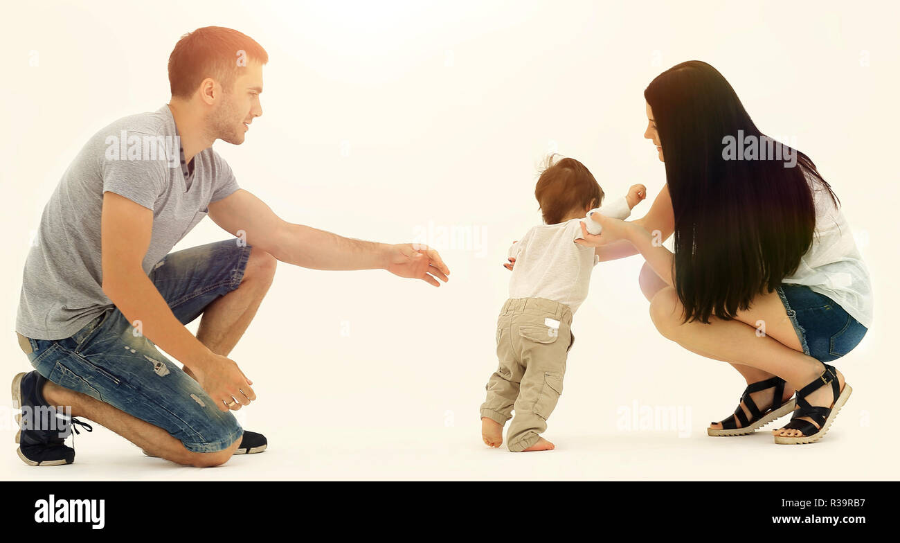 Portrait of a happy family that teaches a child to walk Stock Photo - Alamy