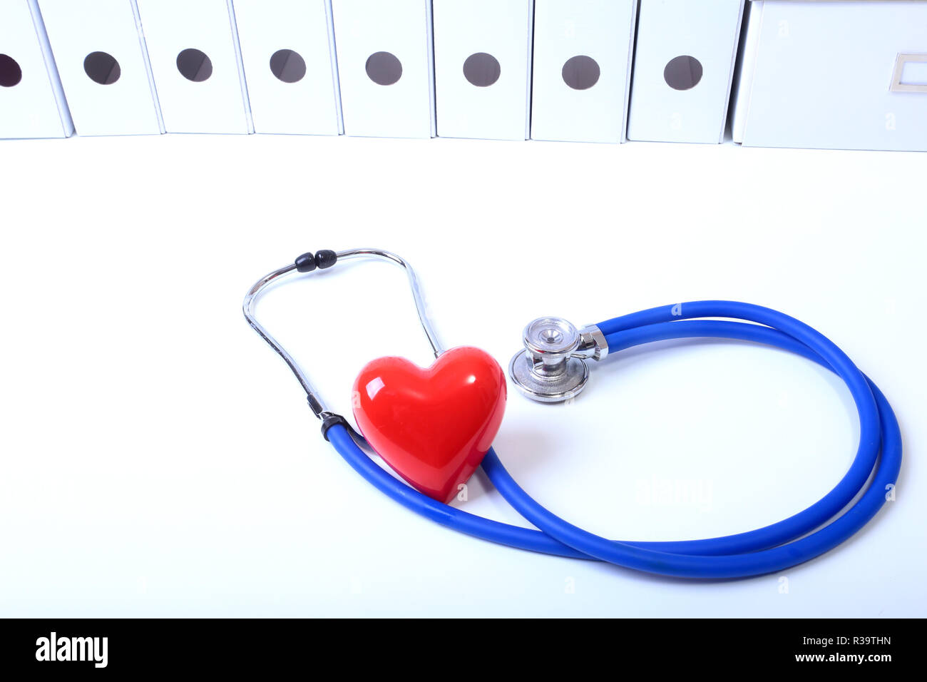 Heart with a medical stethoscope, isolated on wooden background Stock ...