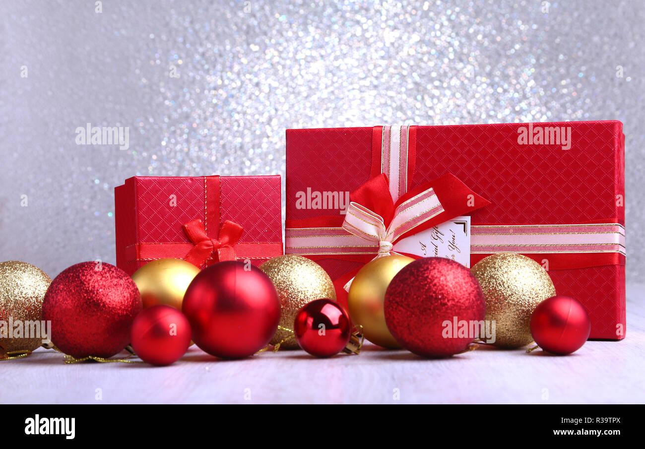 Colorful red gifts with Christmas balls isolated on silver background ...