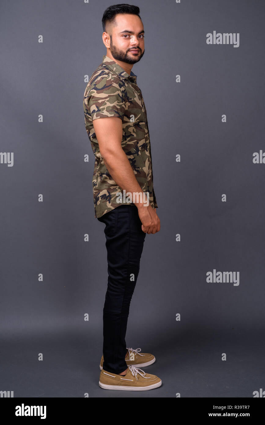 Young bearded Indian man against gray background Stock Photo - Alamy