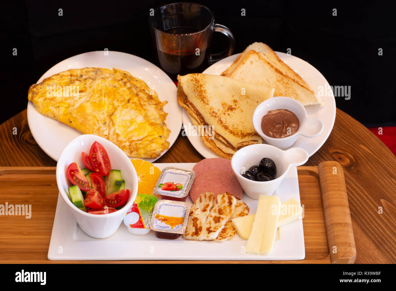 Traditional Turkish breakfast with omelette, pancake, tea, fruits and ...
