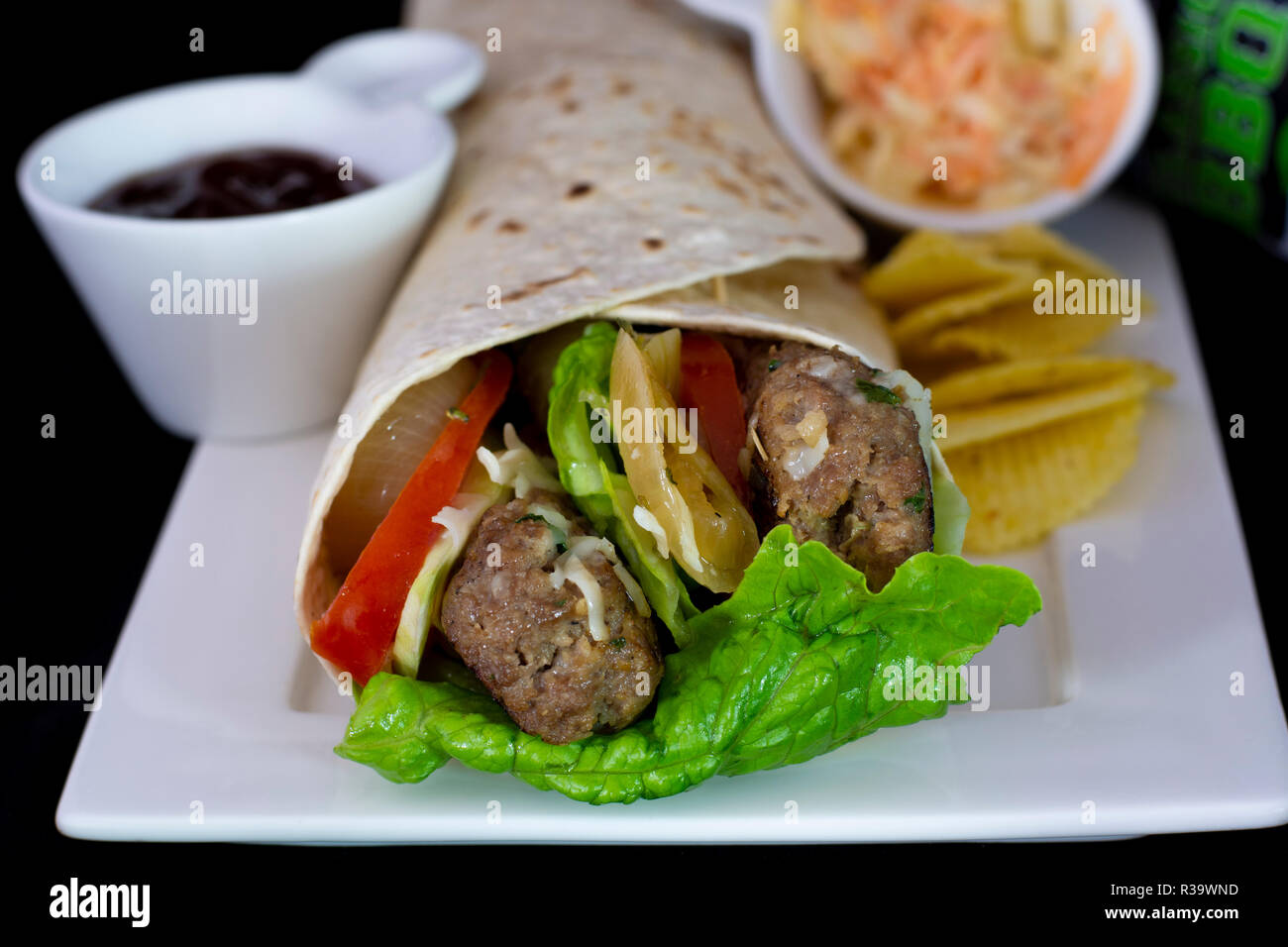 Delicious meatball wrap with salad inside with isolated black ...