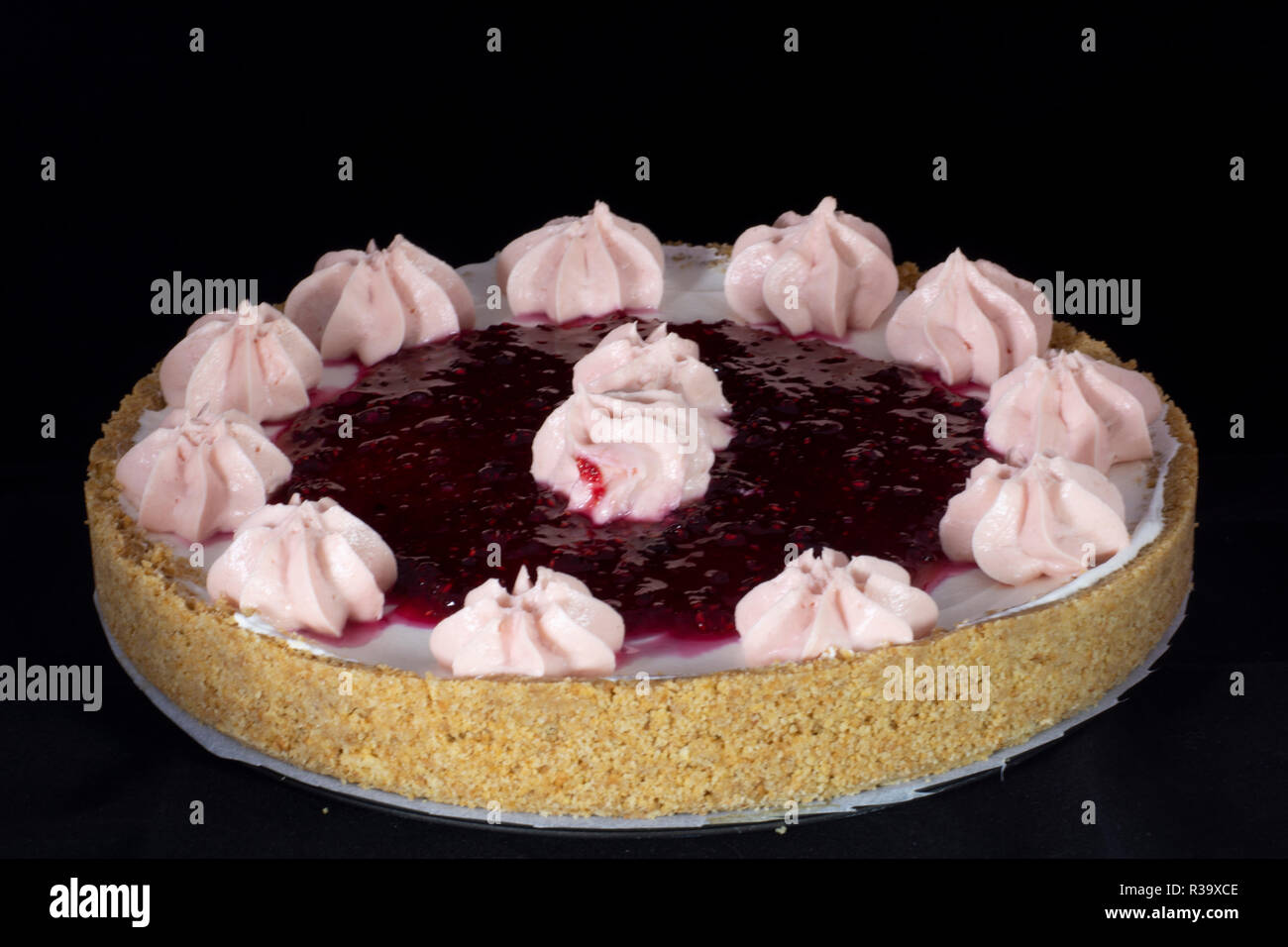 Fresh baked raspberry pie with whipped cream decorations on top with ...