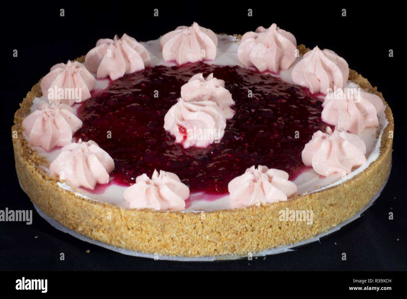 Fresh baked raspberry pie with whipped cream decorations on top with ...