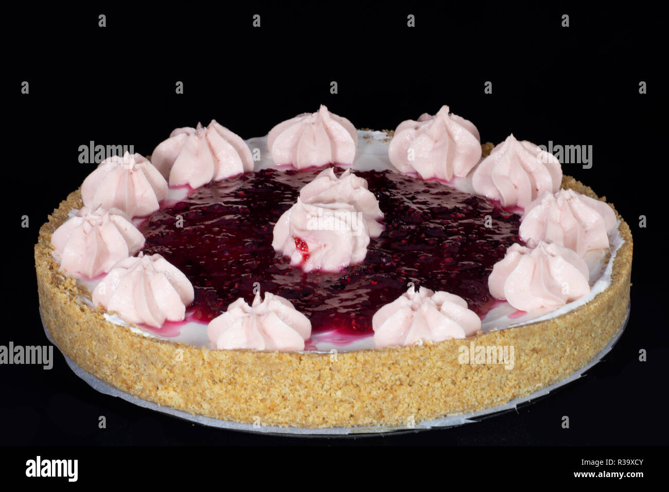 Fresh baked raspberry pie with whipped cream decorations on top with ...