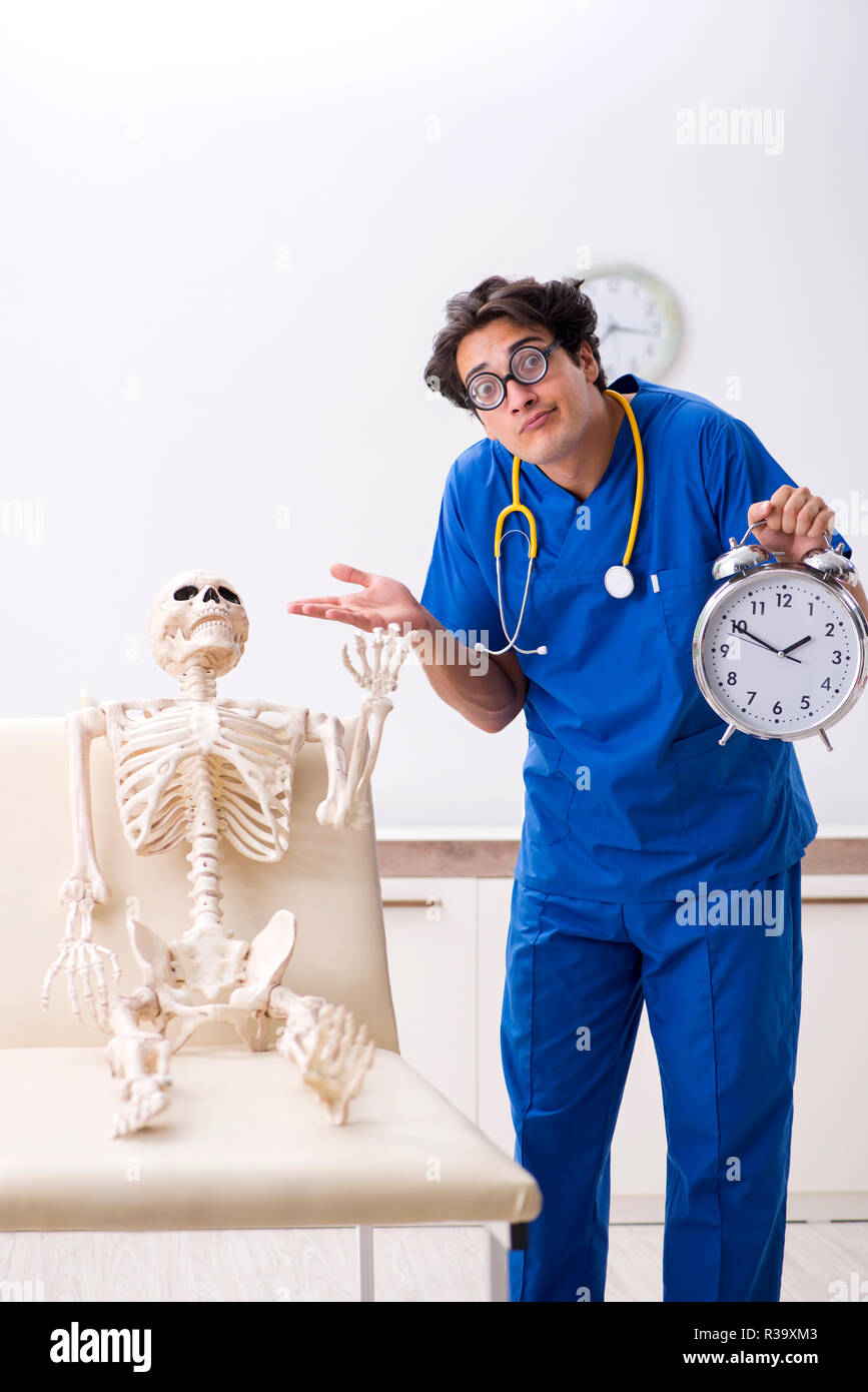 Funny doctor with skeleton in hospital Stock Photo - Alamy