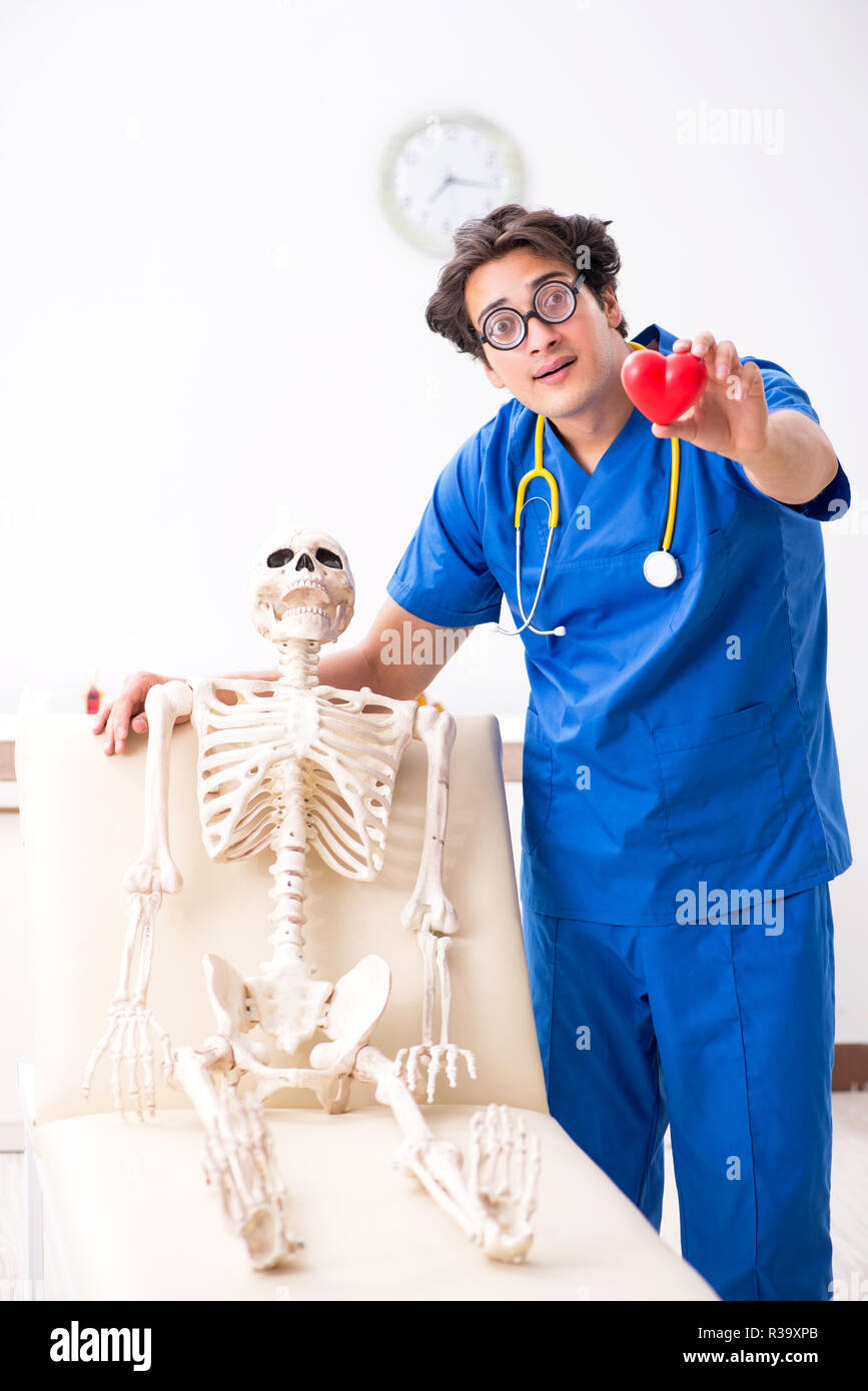 Funny doctor with skeleton in hospital Stock Photo - Alamy