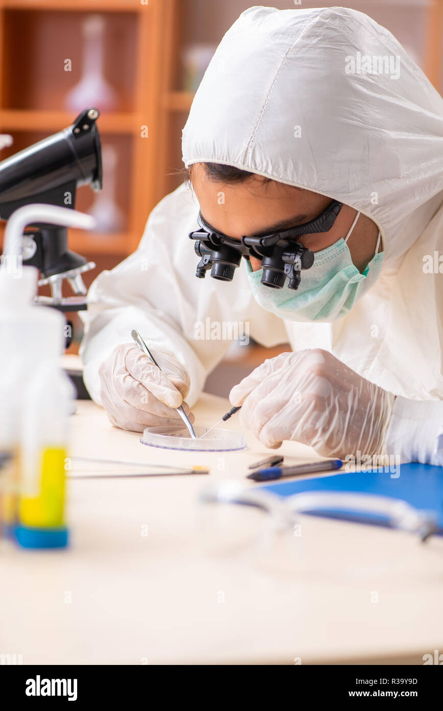 Young biochemist wearing protective suit working in the lab Stock Photo ...