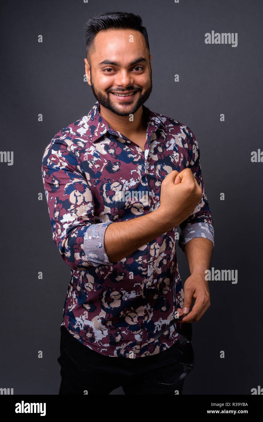 Young bearded Indian man against gray background Stock Photo - Alamy