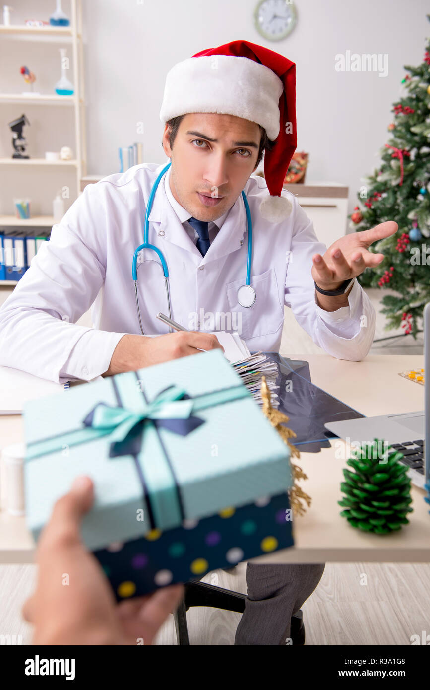 Doctor with gift box in the hospital Stock Photo - Alamy