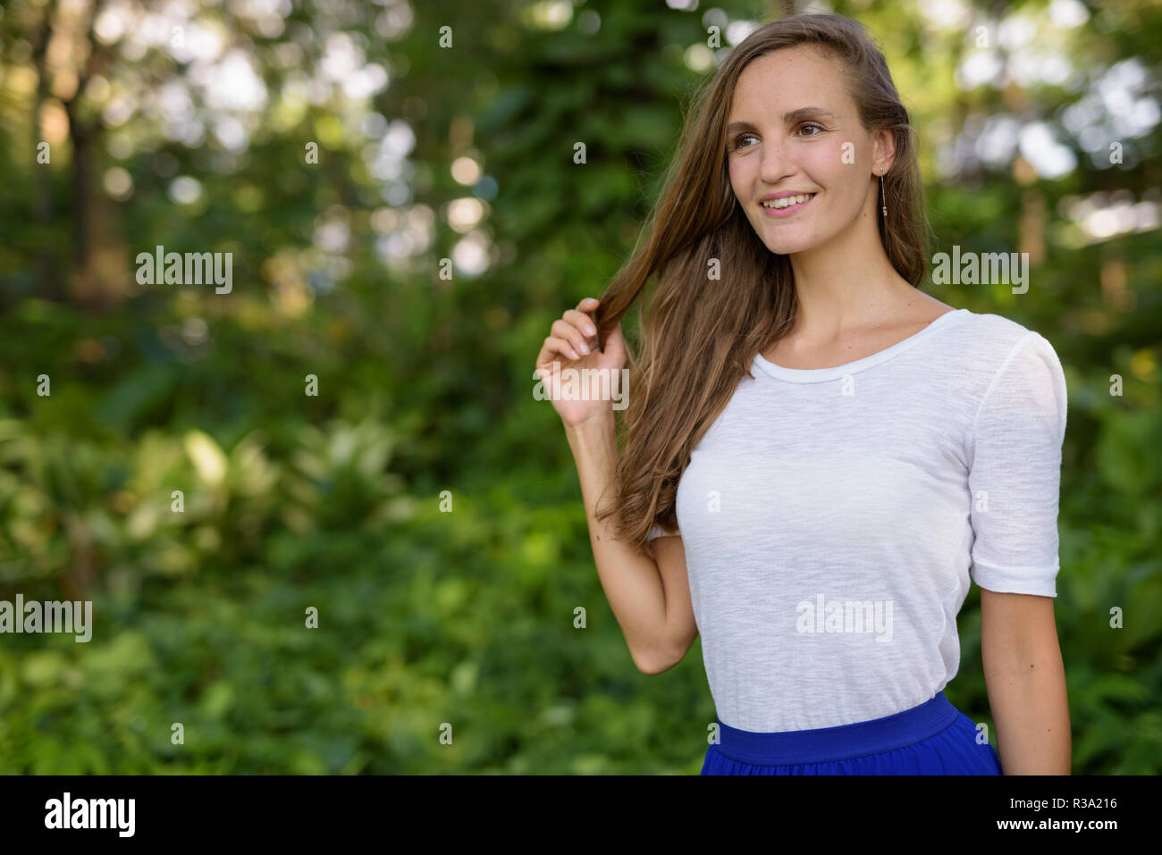 Happy beautiful woman smiling and thinking while touching her ha Stock ...