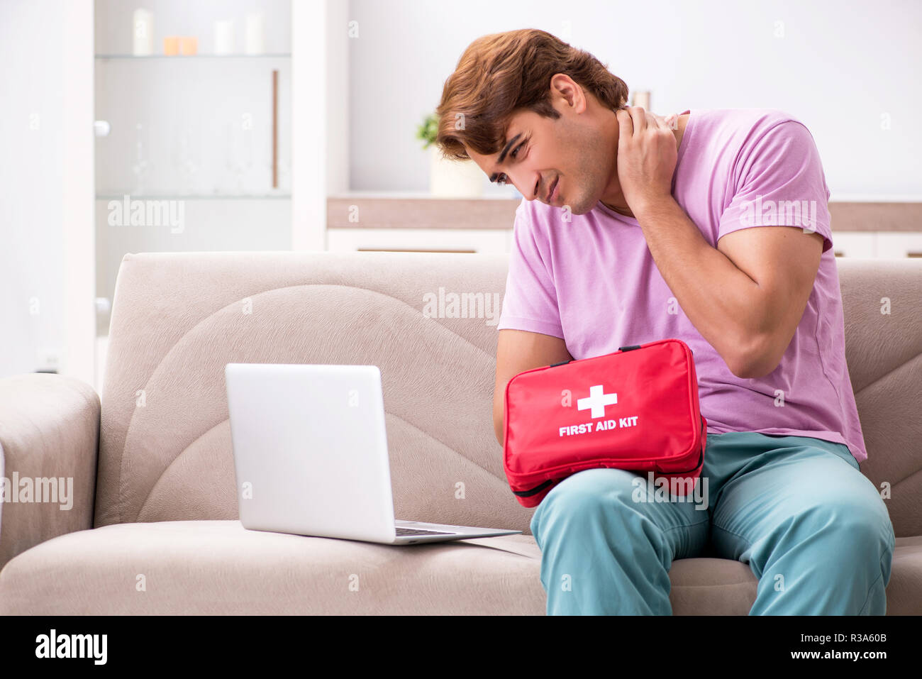 Sick man at home with first aid kit Stock Photo - Alamy