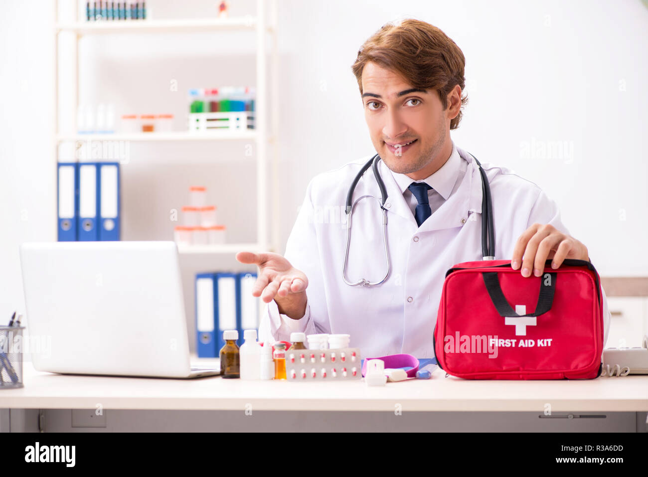 Young doctor with first aid kit in hospital Stock Photo - Alamy