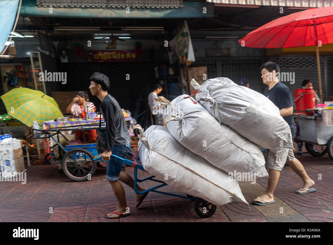Men seen transporting goods in Chinatown, Bangkok, Thailand. Daily life ...