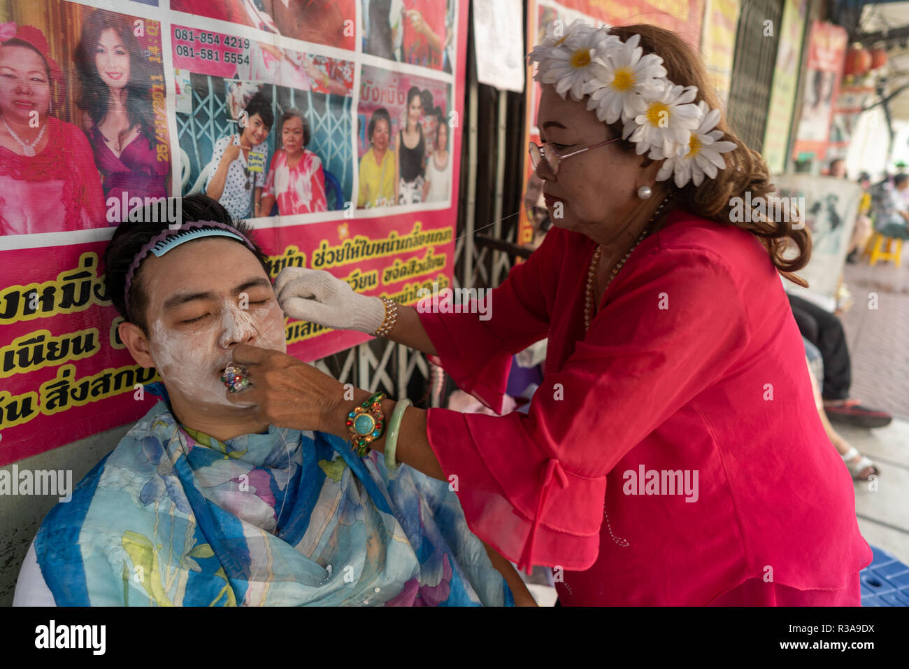 A man seen getting a facial in Chinatown, Bangkok, Thailand. Daily life ...