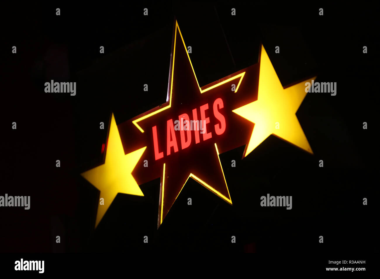 A Ladies sign lit up in the dark with stars in Sussex, UK Stock Photo ...