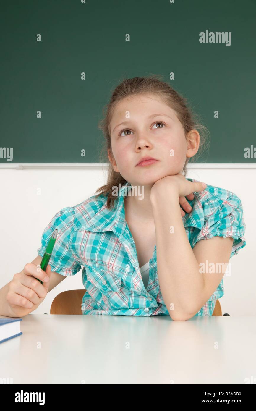 schoolgirl sitting at table in school Stock Photo - Alamy
