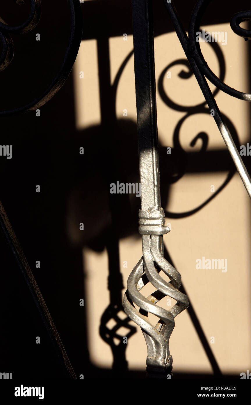wrought-iron railing casts shadows on the wall Stock Photo - Alamy