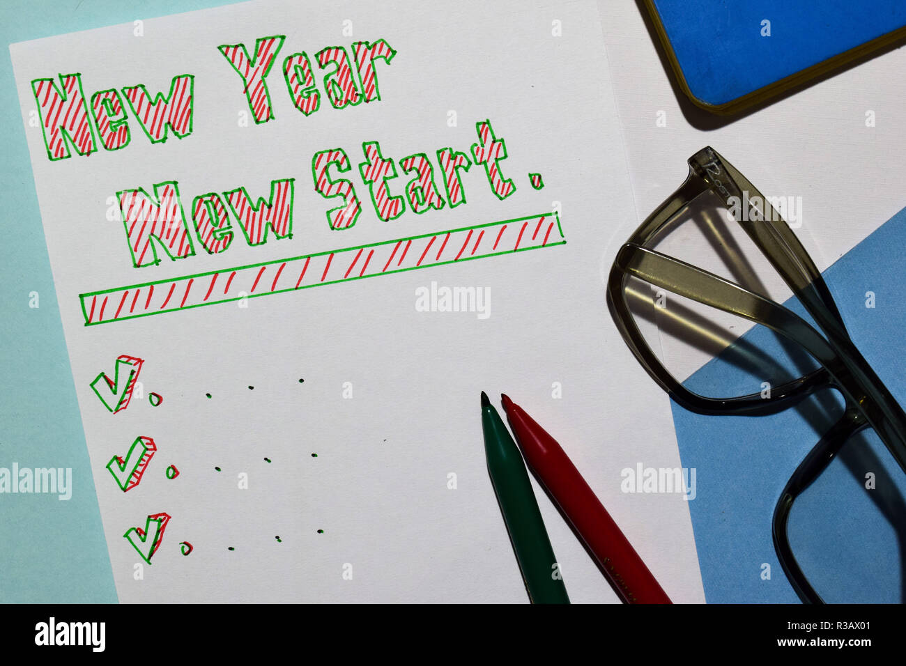 Top view NEW YEAR NEW START text list with marker and eyeglasses for ...