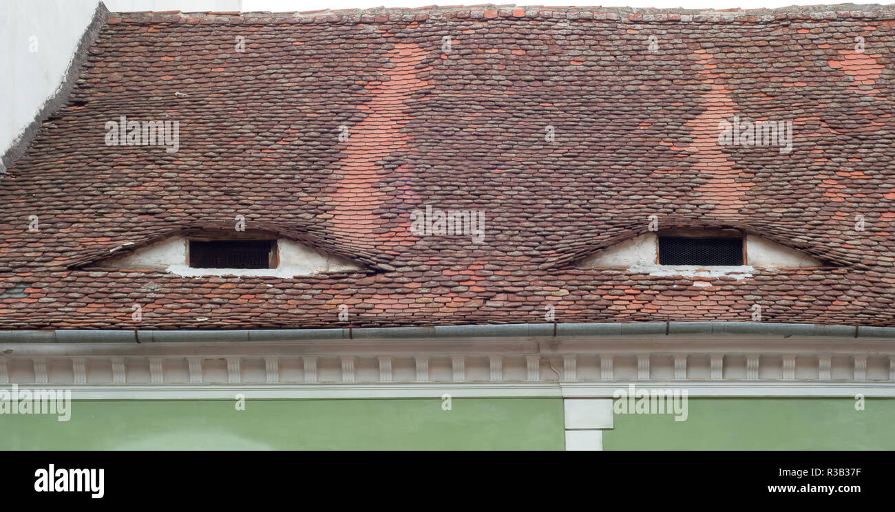 Roof with eye-like windows in Sibiu, Romania Stock Photo - Alamy