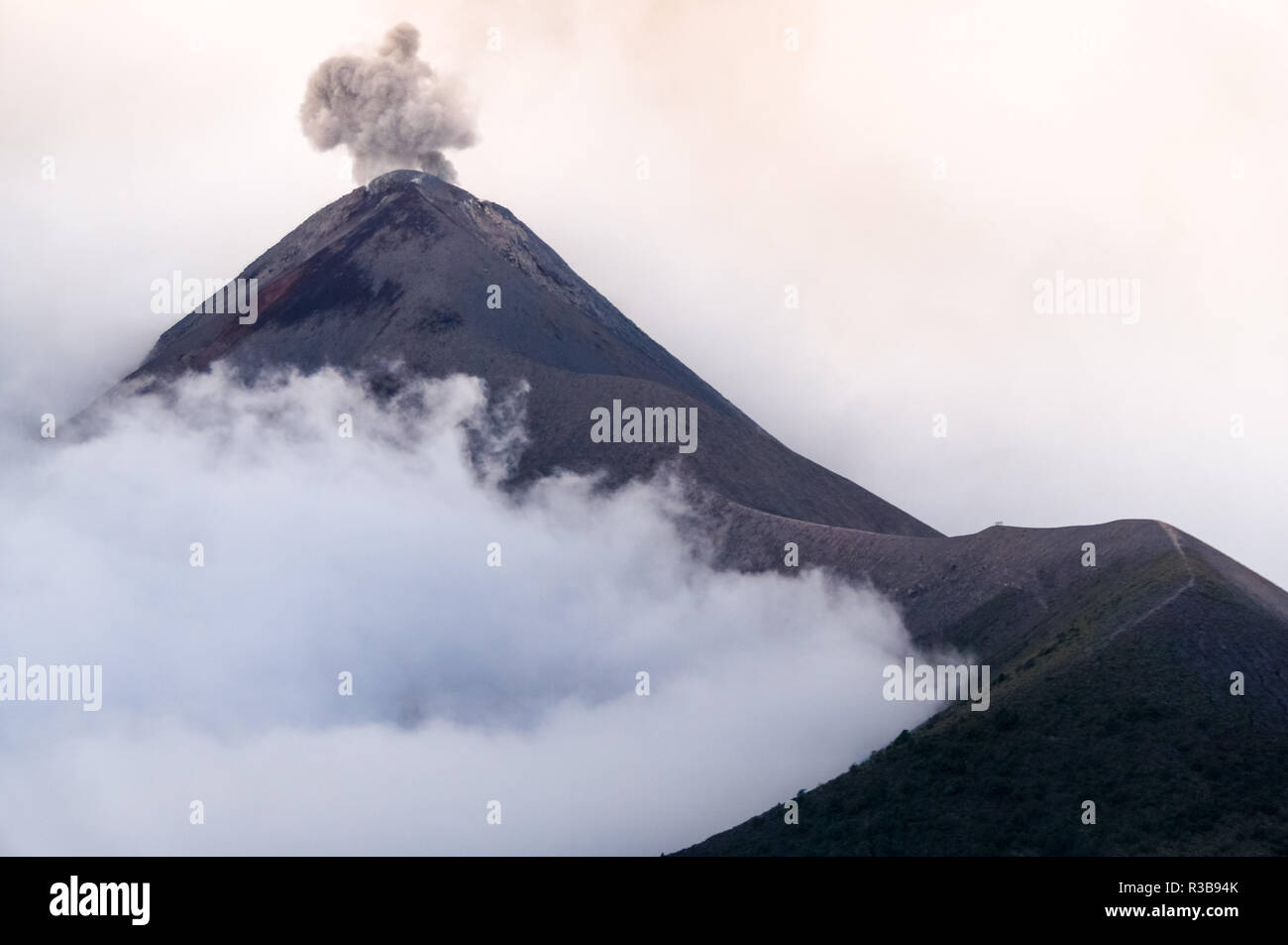 Eruption of volcano Fuego in cloudy and misty weather. Black and white ...