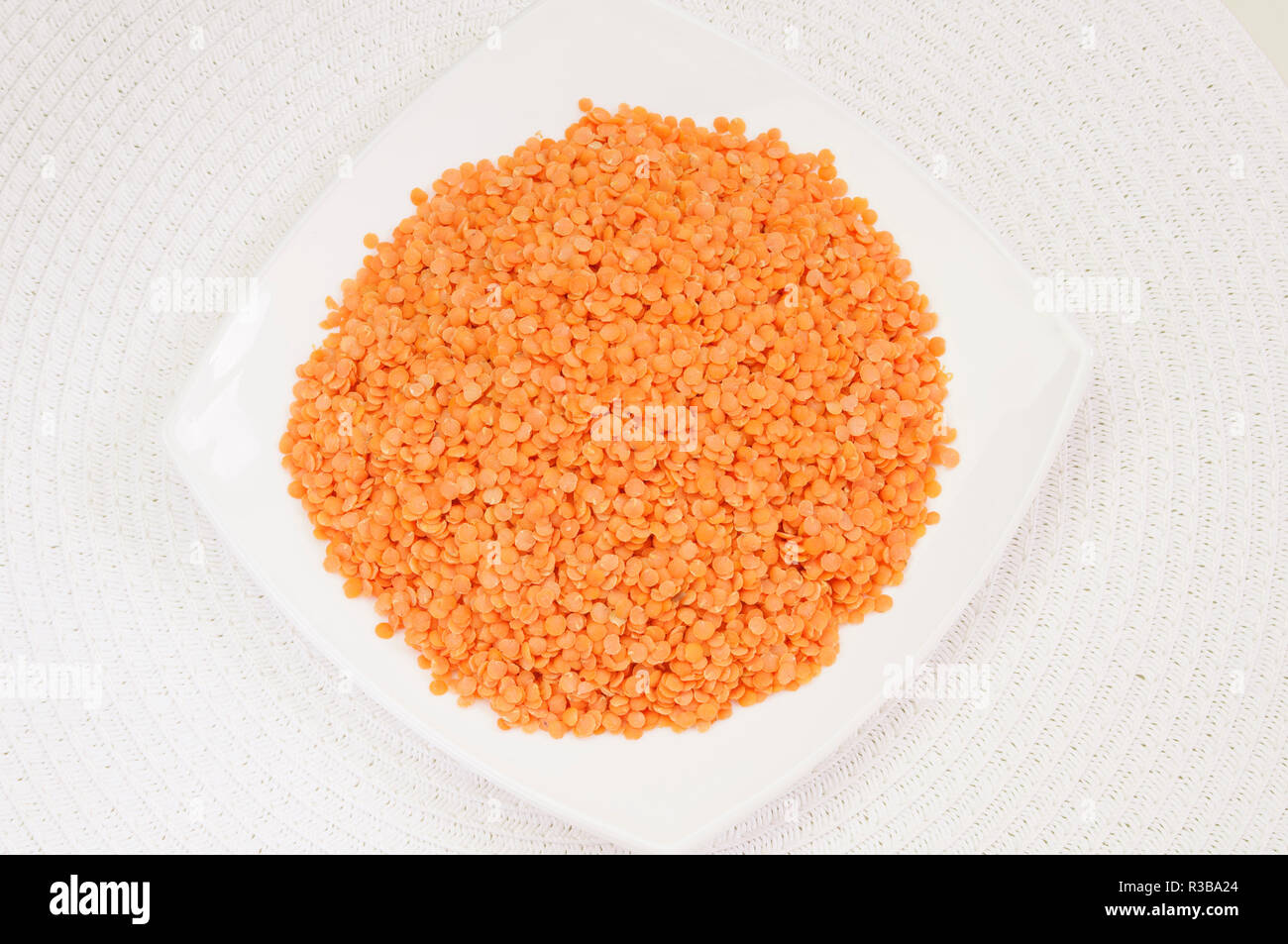 Red lentils on a plate ready to be cooked Stock Photo - Alamy