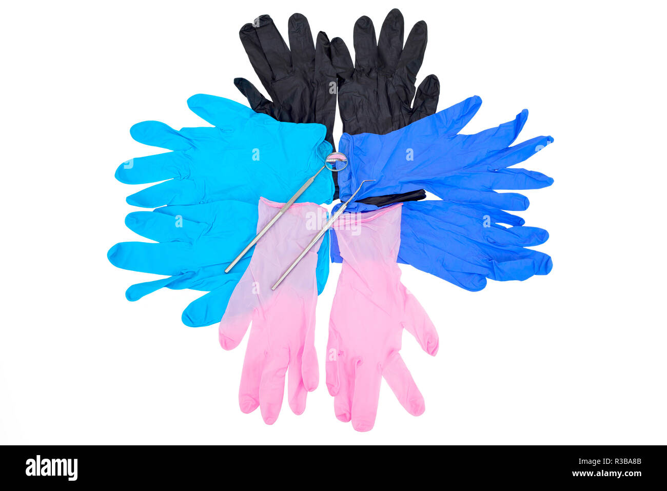 Colorful gloves with dental instruments isolated on white background ...