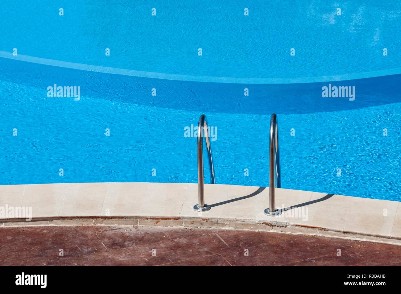 Beautiful empty swimming pool with blue water Stock Photo - Alamy