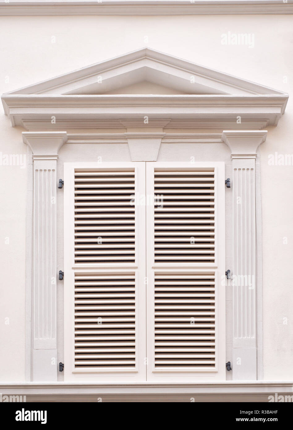 White window with shutters on white wall Stock Photo - Alamy
