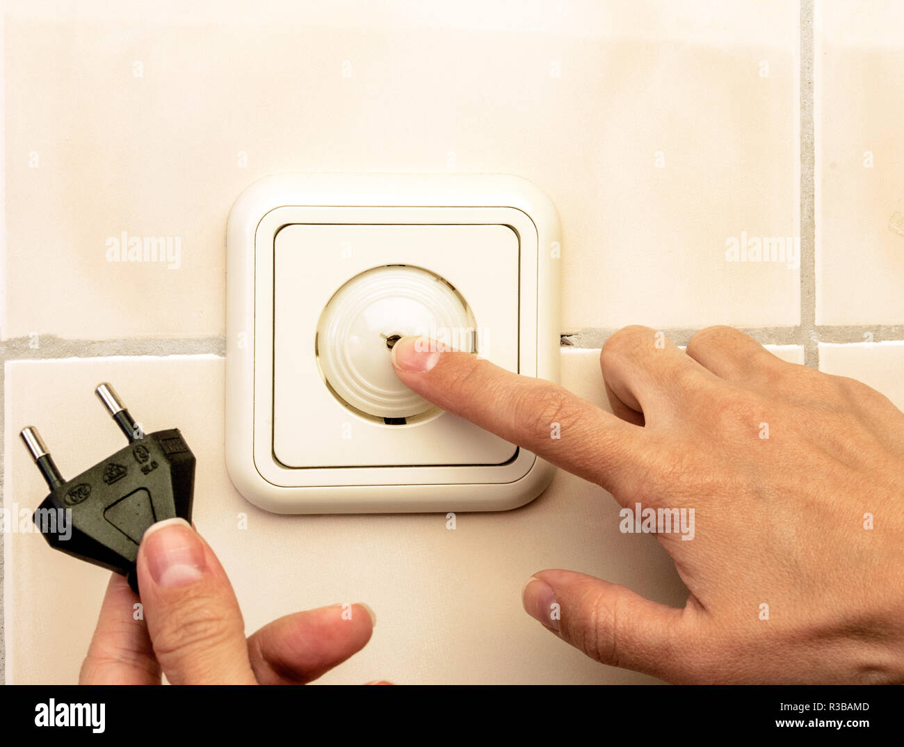 Woman hands putting a white socket protection Stock Photo - Alamy