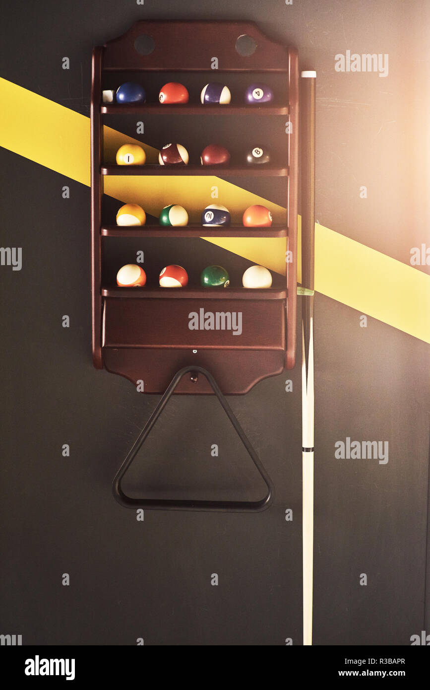 Stand with equipment for american billiards. Cue balls and triangle ...