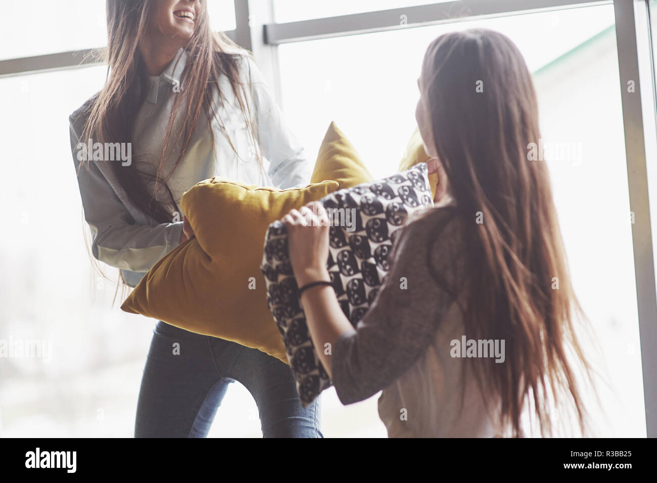 Two beautiful young twins sisters spending time together and are ...