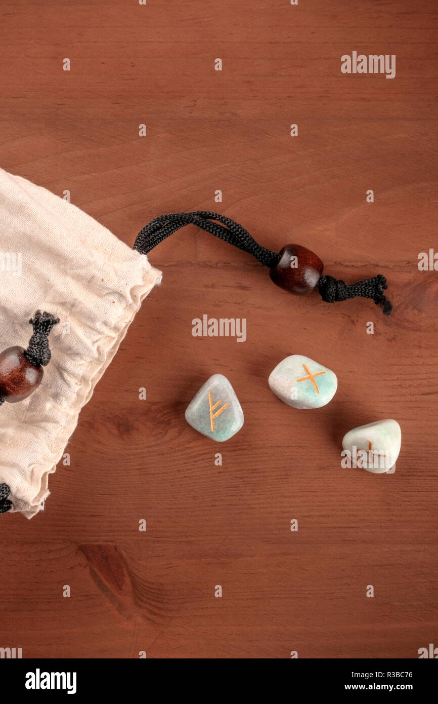 A closeup overhead photo of Norse runes, stones with symbols used in ...