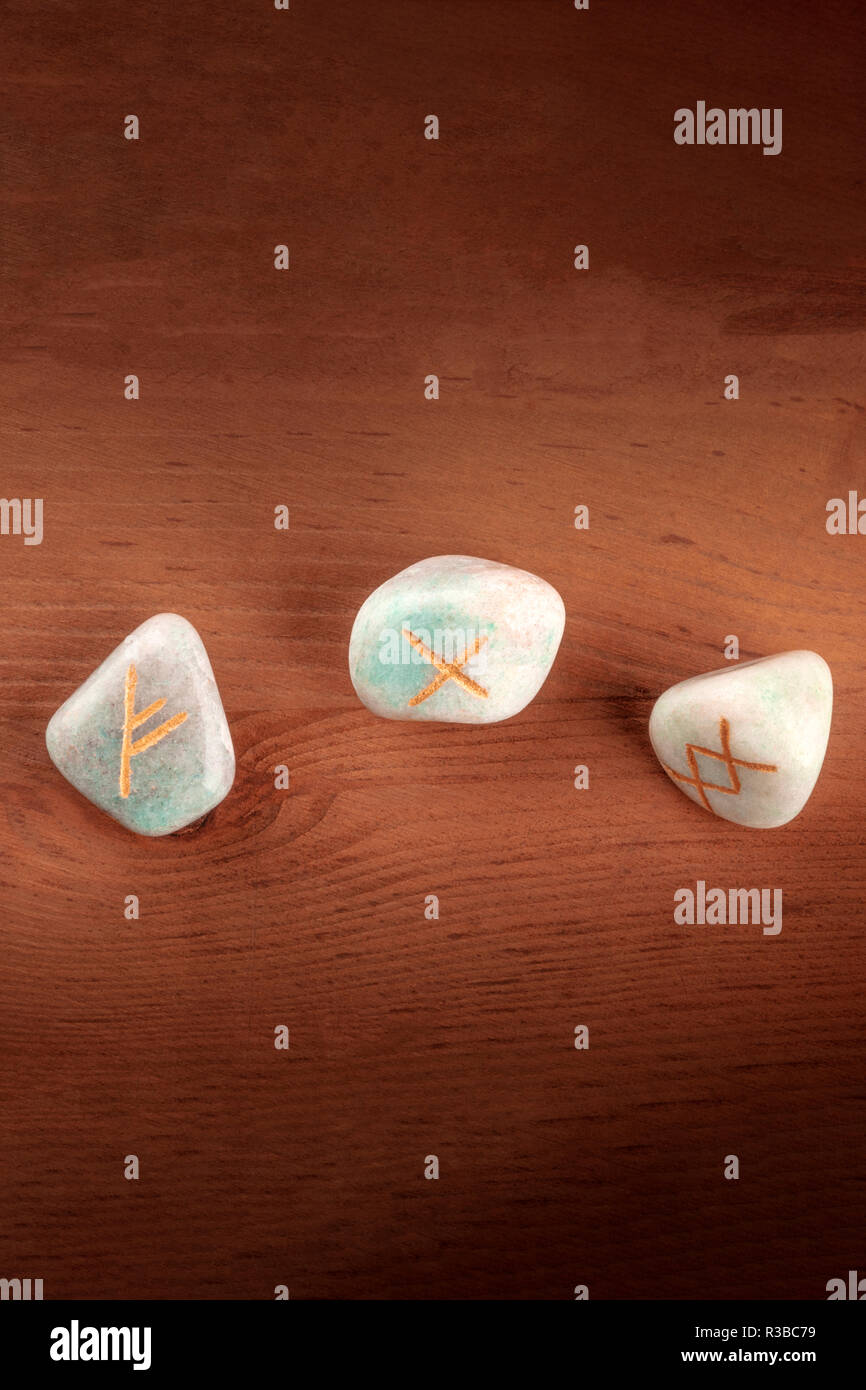 A closeup overhead photo of Norse runes from the Futhark alphabet ...