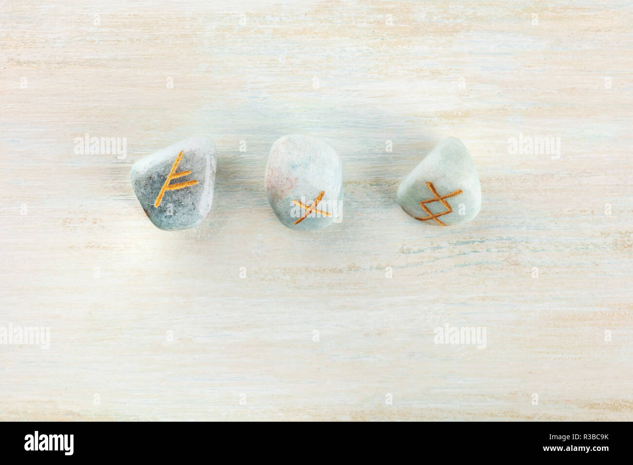 A closeup overhead photo of Norse runes from the Futhark alphabet ...